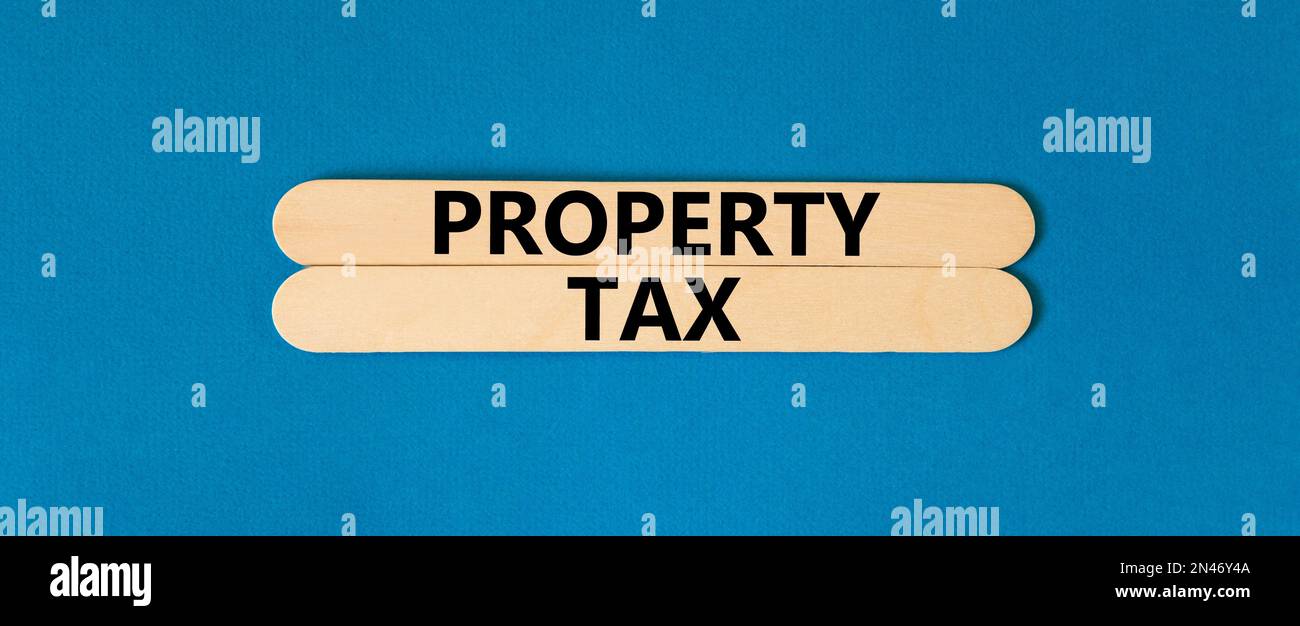 Property tax symbol. Concept words Property tax on wooden stick ...