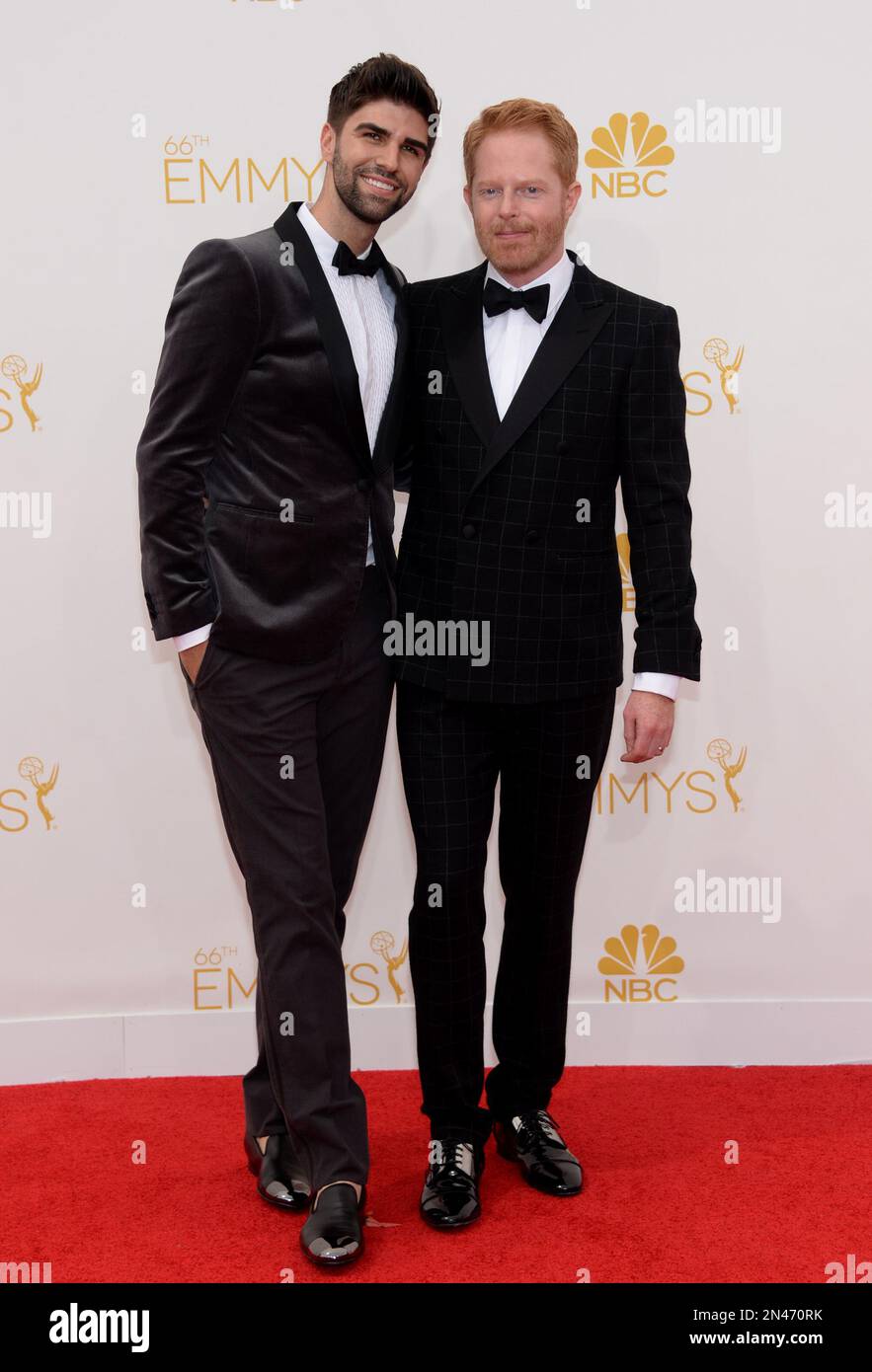 Justin Mikita, left and Jesse Tyler Ferguson arrives at the 66th ...