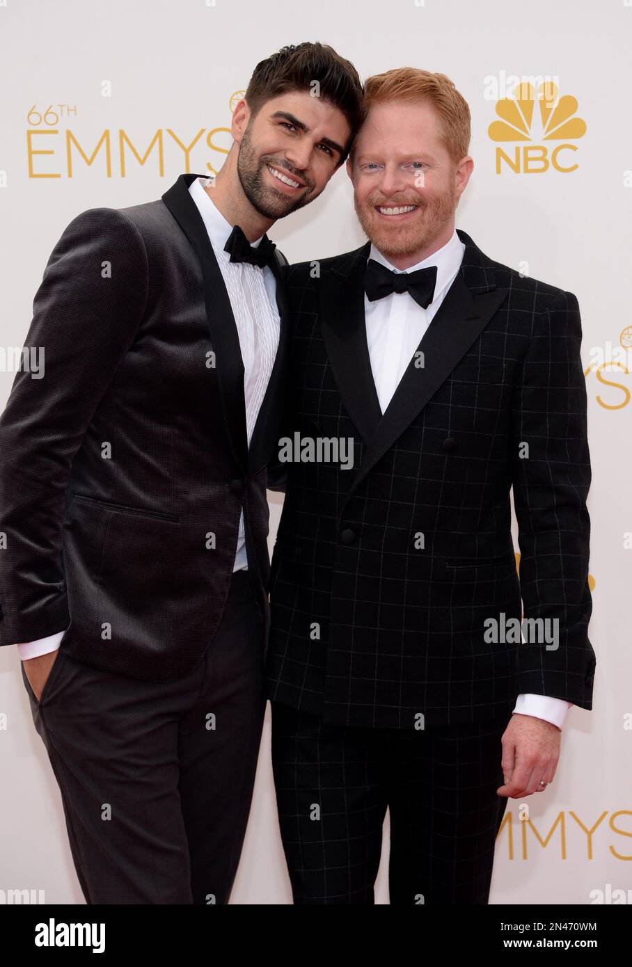Justin Mikita, left and Jesse Tyler Ferguson arrives at the 66th ...