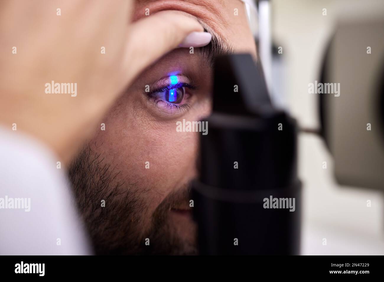 Eye exam, vision or laser test for a man with machine at optometry ...
