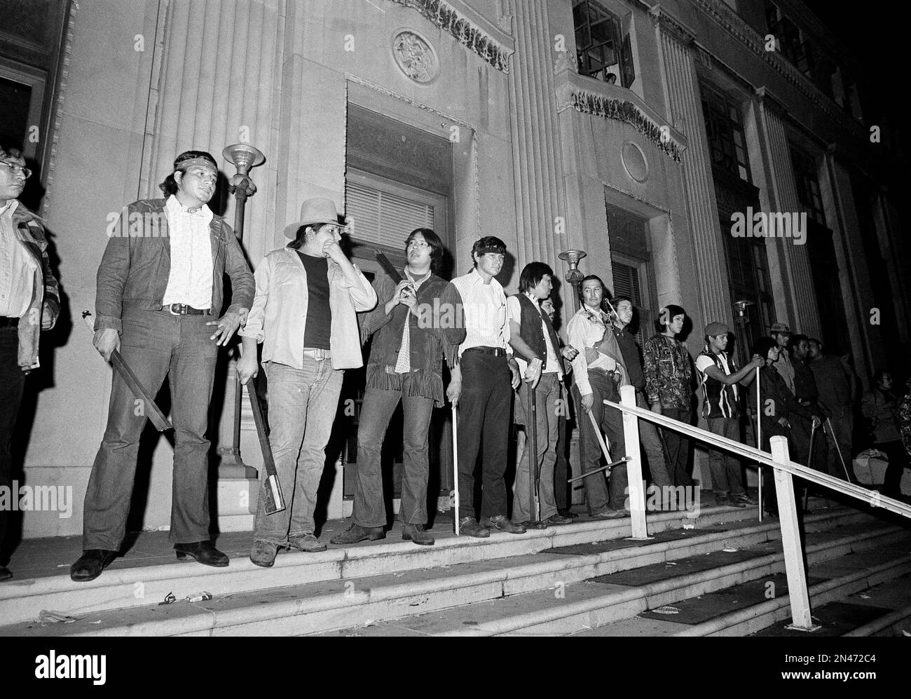 Members of American Indian Movement, aka AIM, stand guard with clubs in ...