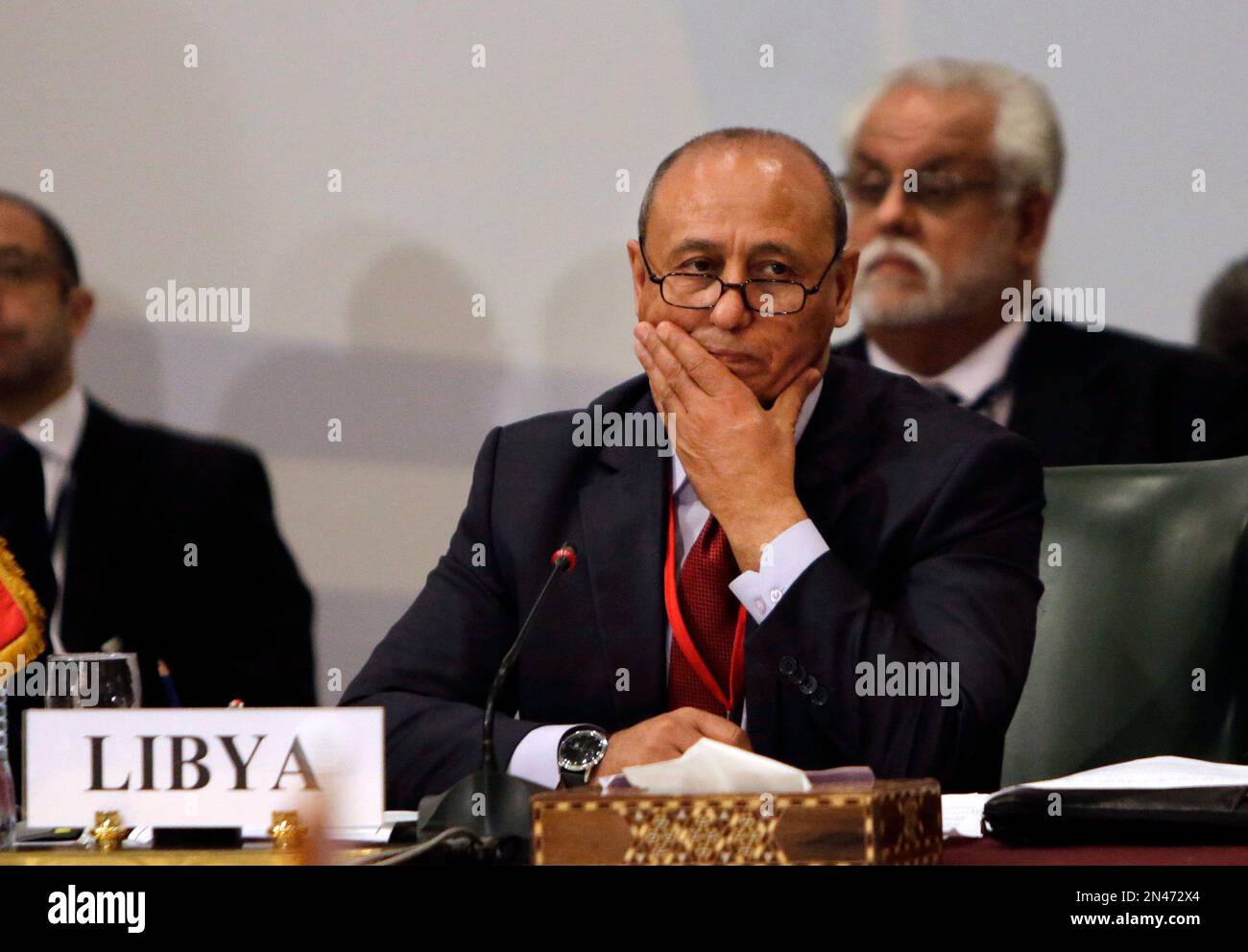 Libyan Foreign Minister Mohamed Abdelaziz, second left, attends a Cairo ...