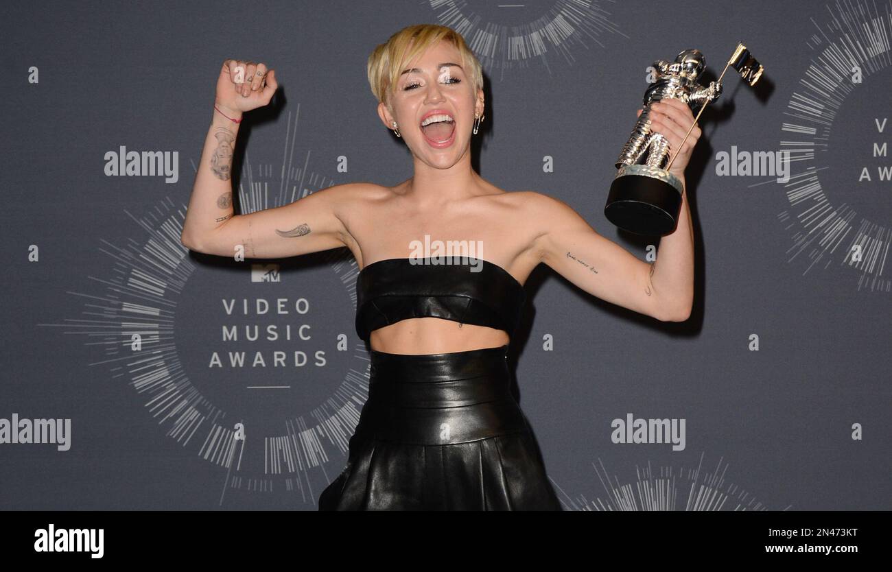 Miley Cyrus poses with the Video of the Year award in the press room at ...