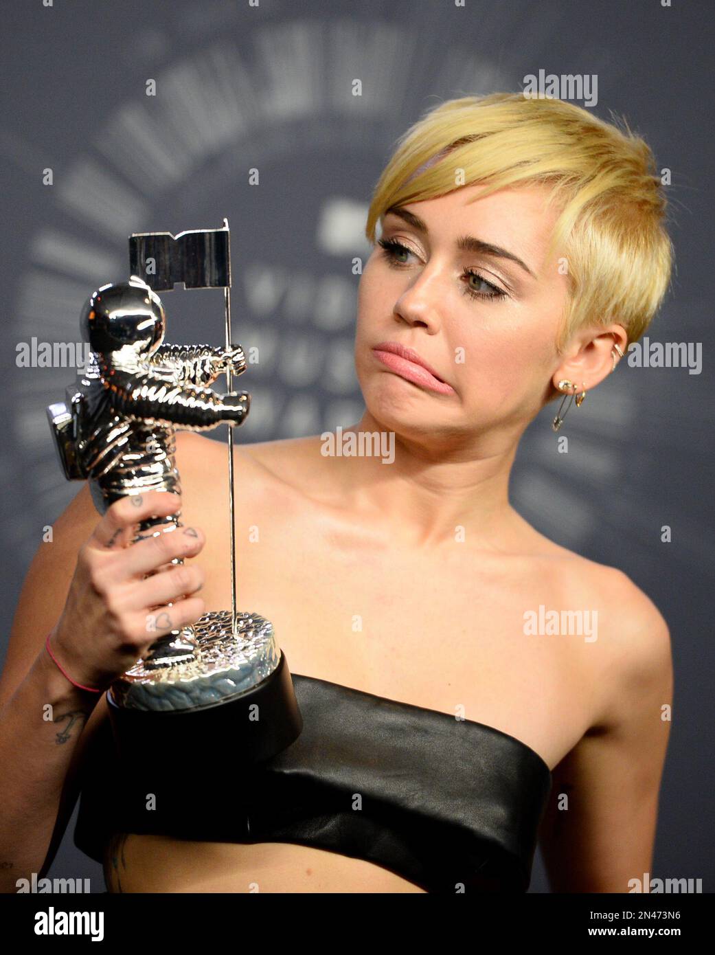 Miley Cyrus poses with the Video of the Year award in the press room at ...