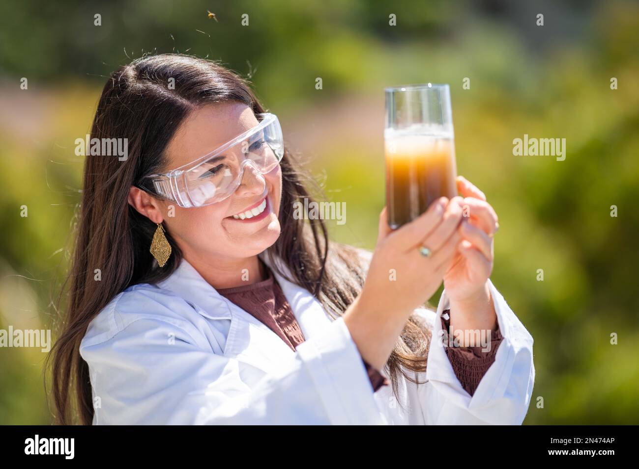 Soil test, female agricultural scientist conducting a soil test in a ...
