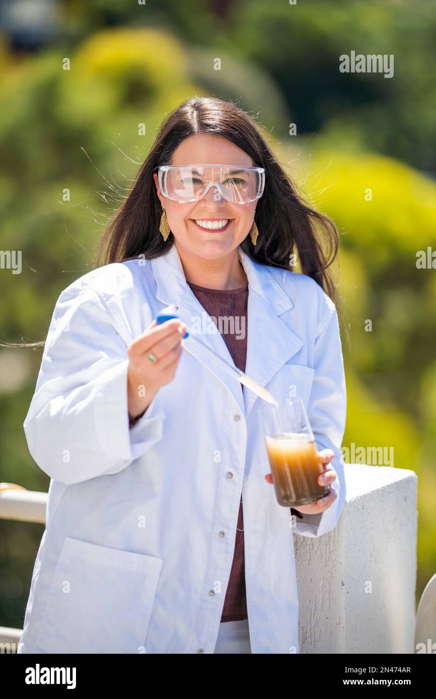 female soil scientist pipette soil solution in a laboratory. scientist ...