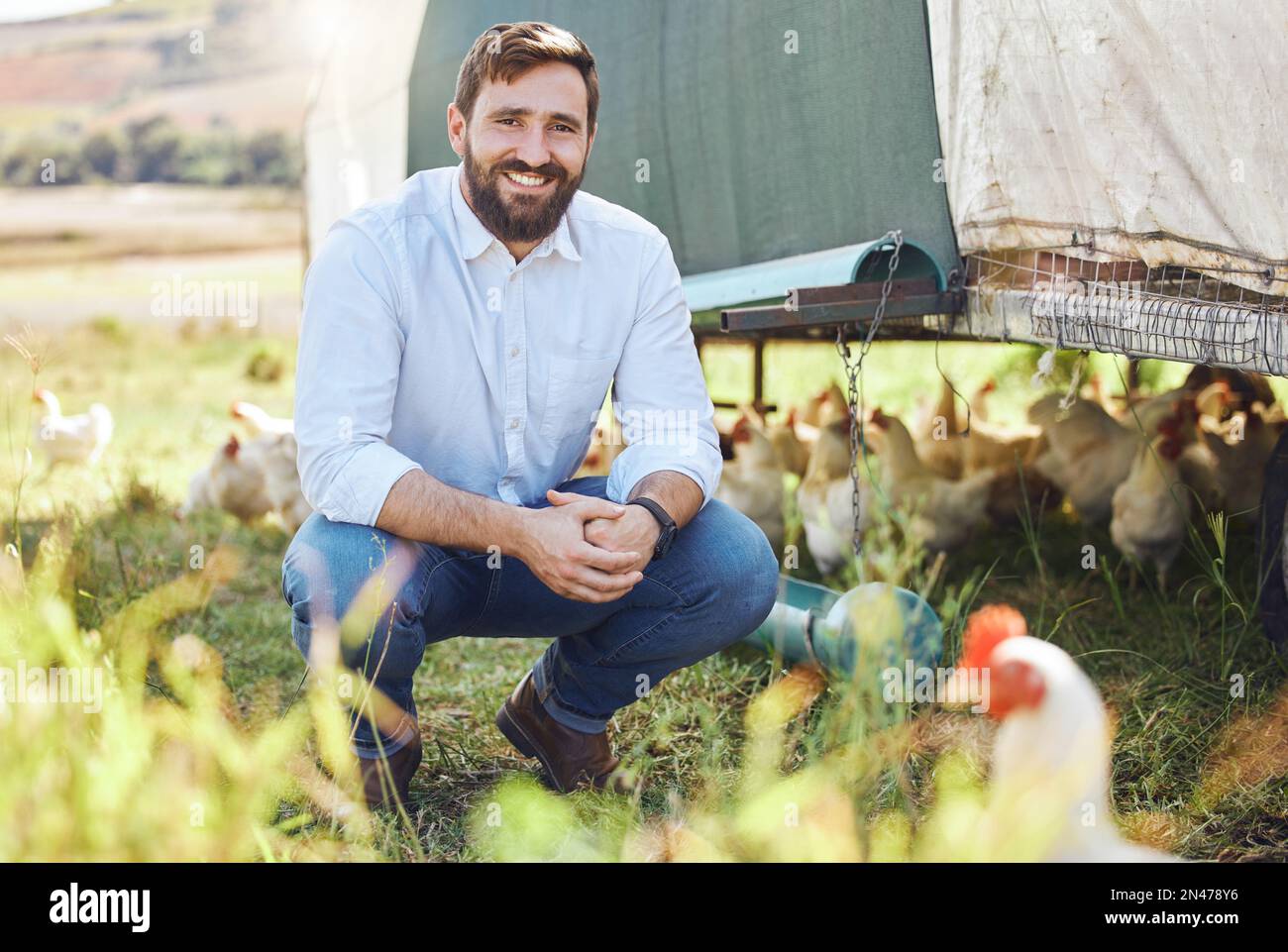 Portrait, man on farm with chicken and agriculture, smile outdoor with ...