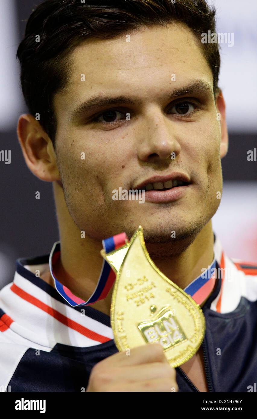 France's Florent Manaudou shows off his gold medal during the ceremony ...