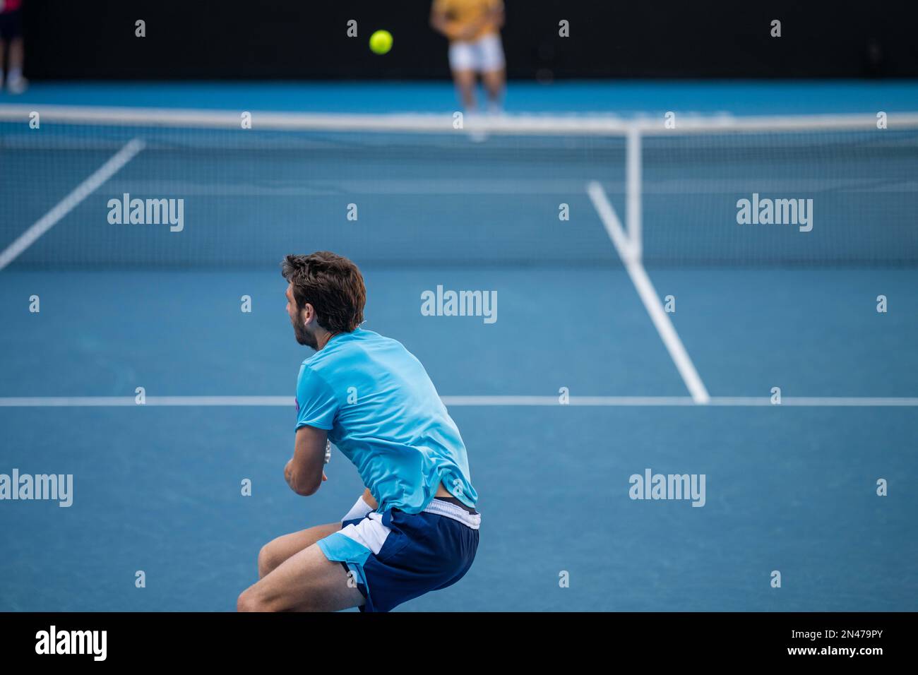 tennis fan watching a tennis match at the australian open eating food ...
