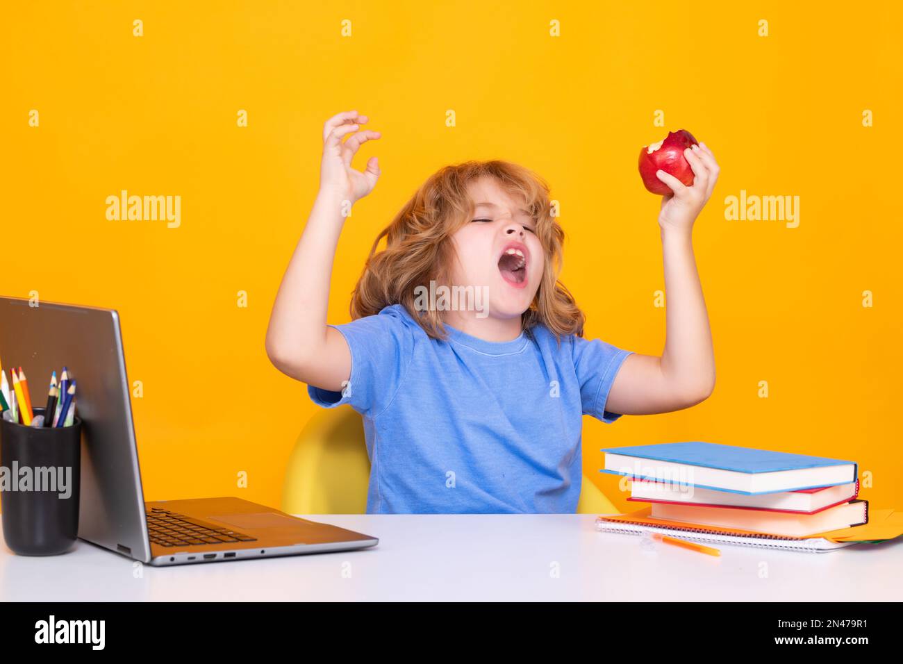 Excited funny pupil. Little student school child isolated on studio ...