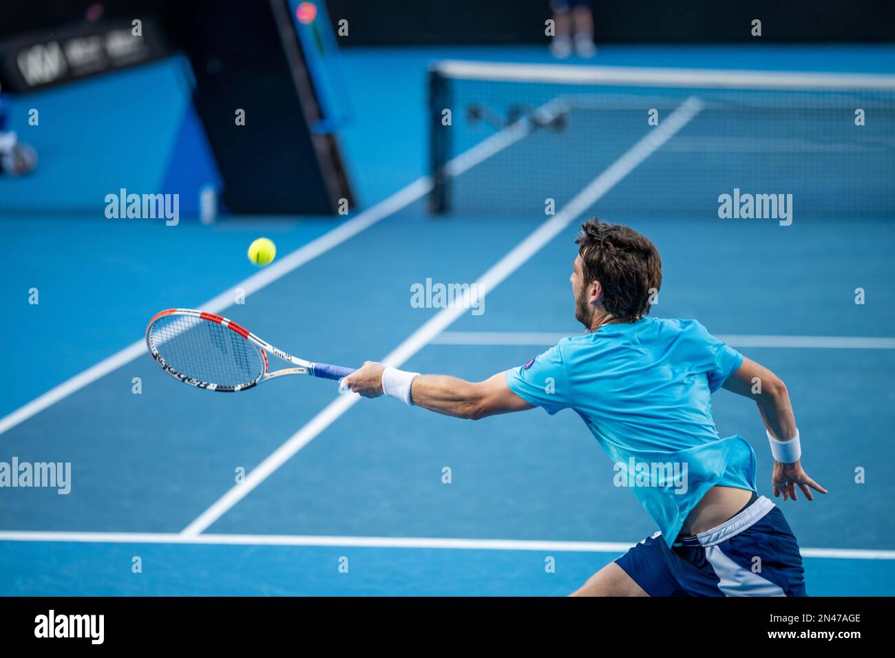 tennis fan watching a tennis match at the australian open eating food ...