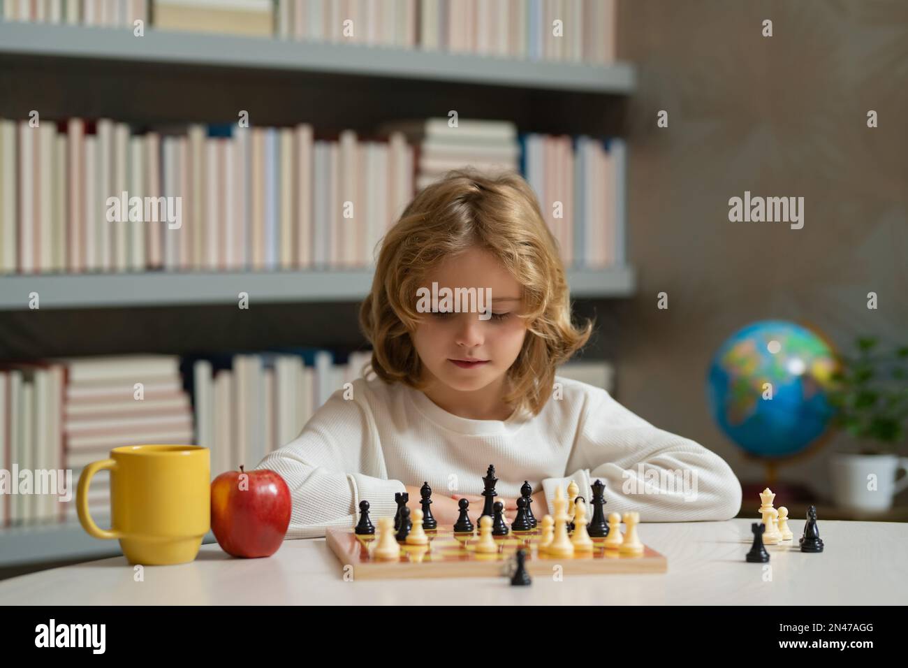 Child boy developing chess strategy, playing board game. Intelligent ...