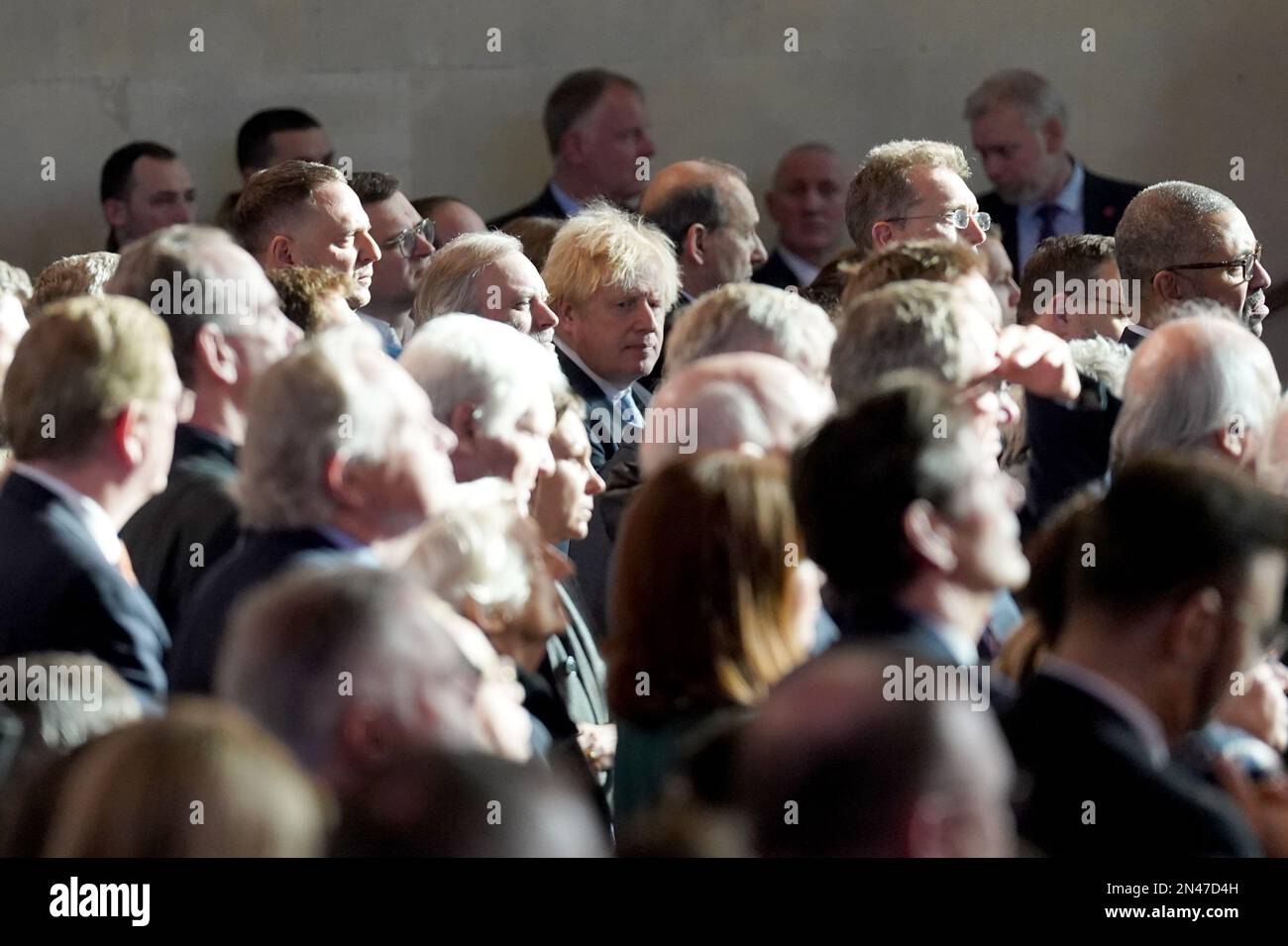 Former prime minister Boris Johnson (centre) in the audience listening ...