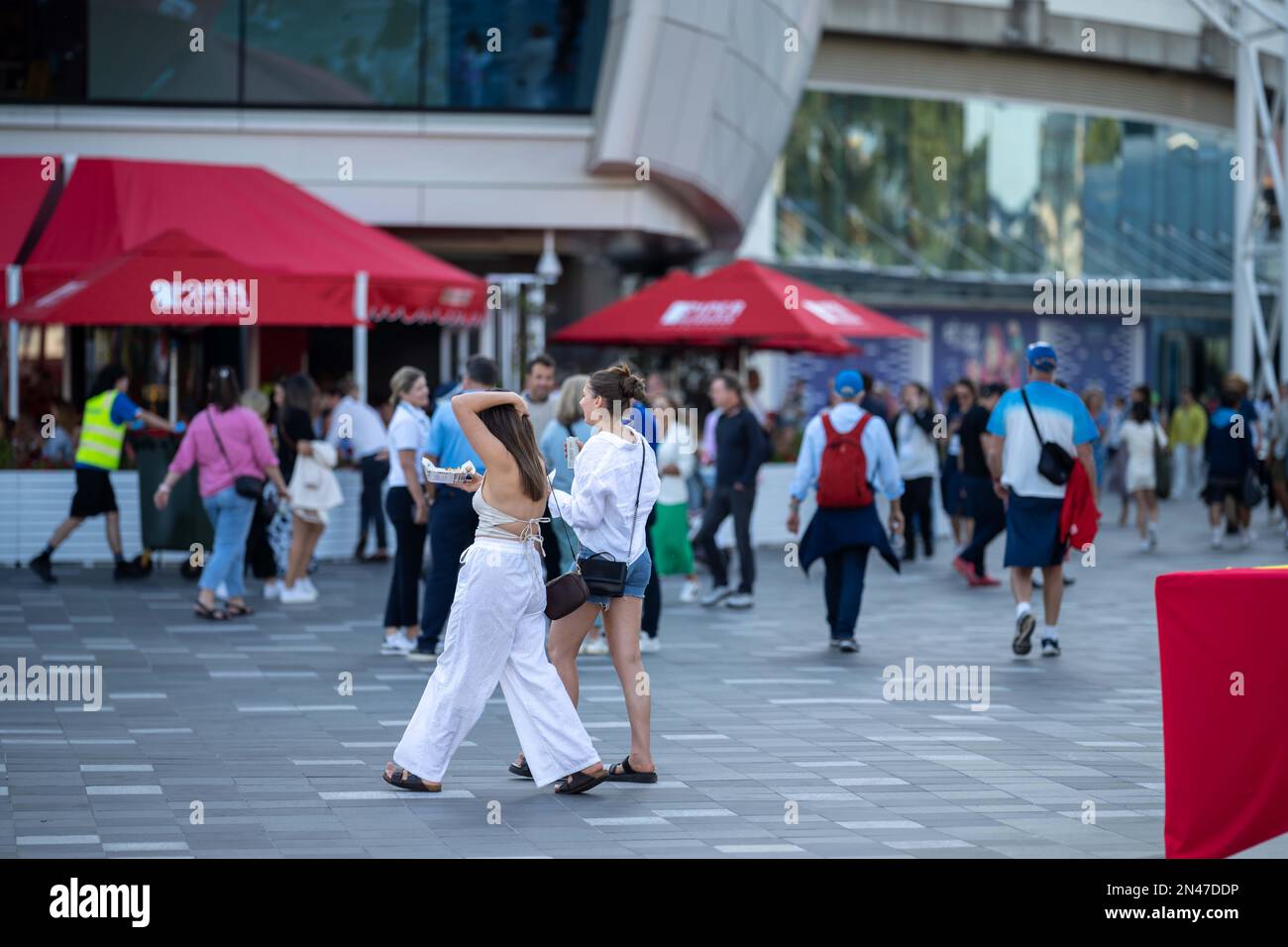 tennis fan watching a tennis match at the australian open eating food ...