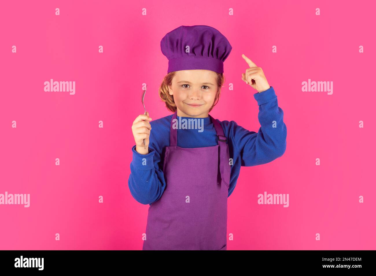 Funny kid chef cook with spoon. Kid in cooker uniform and chef hat ...