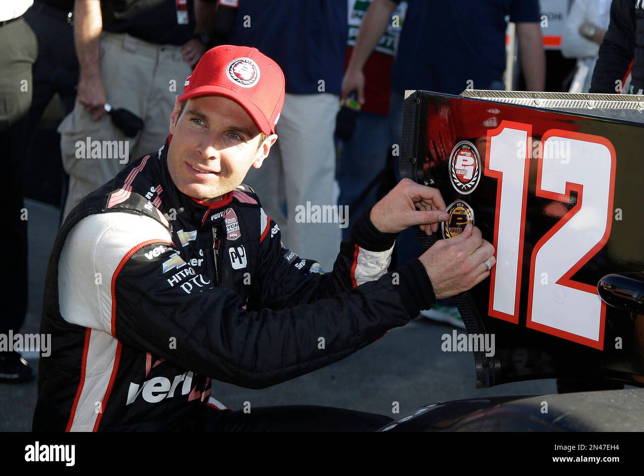 Will Power of Australia poses placing a sticker on his car after ...