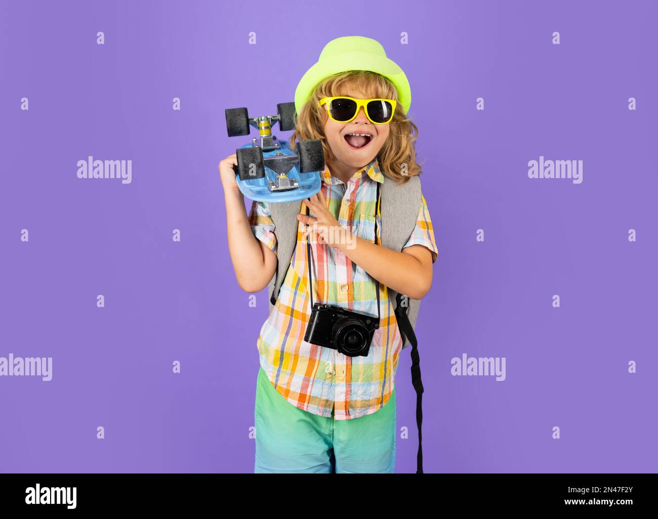 Studio portrait of stylish cute young child boy with skateboard ...