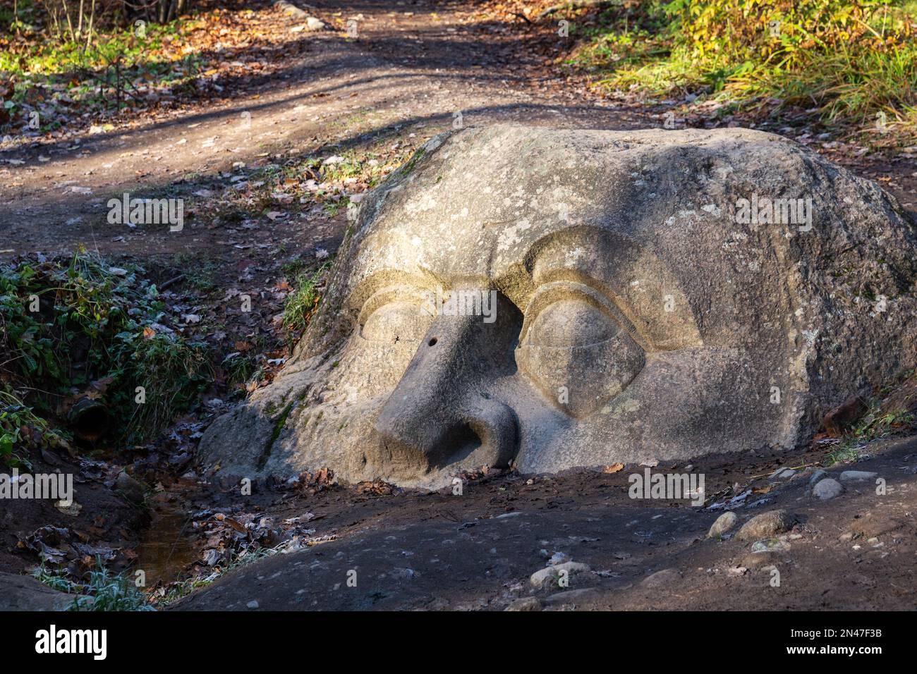 Stone head carved out of a huge boulder in the park of the Sergievka ...