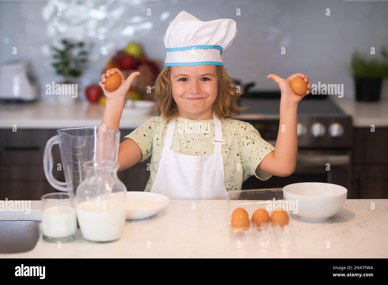 Kid chef cook with eggs at kitchen. Fun kids kitchen. Funny little kid ...