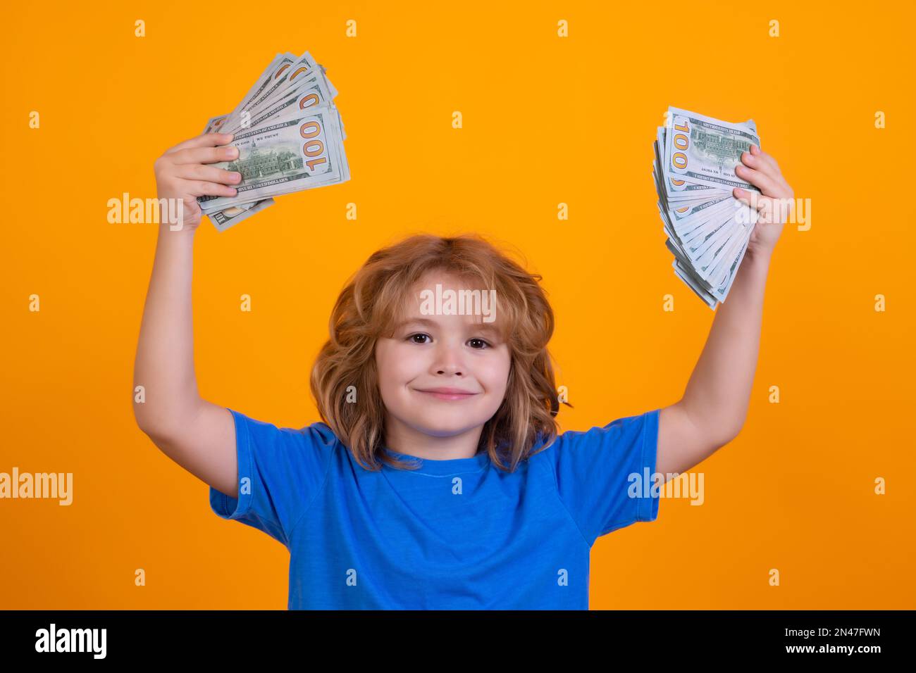 Kid showing money dollar bills, standing dreamy of rich against ...