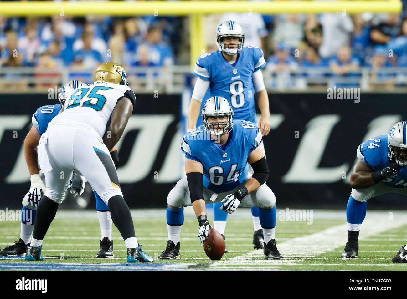 Detroit Lions center Travis Swanson (64) gets set tohick the ball to ...