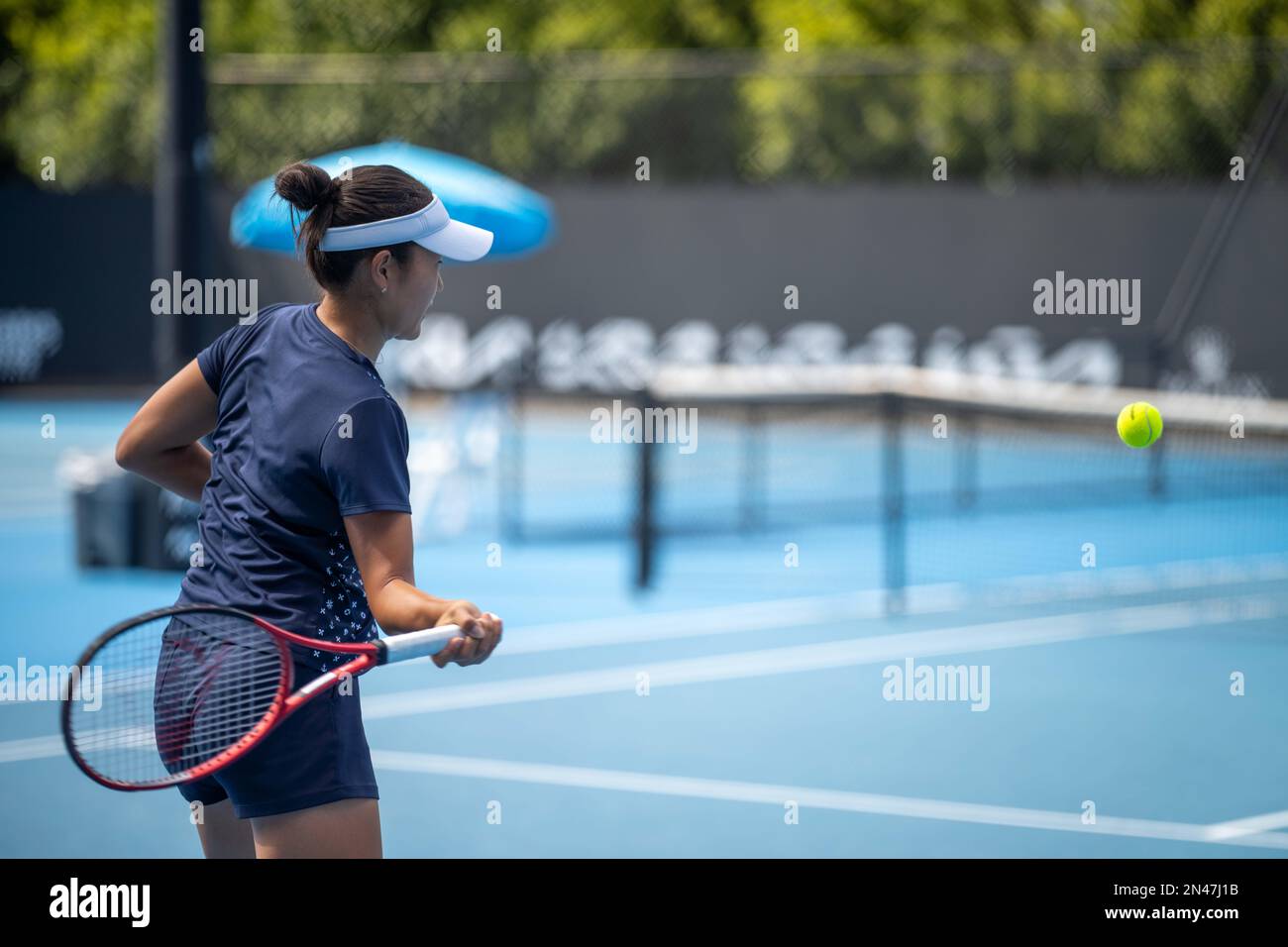 Beautiful female athlete playing tennis. Amateur female tennis player ...