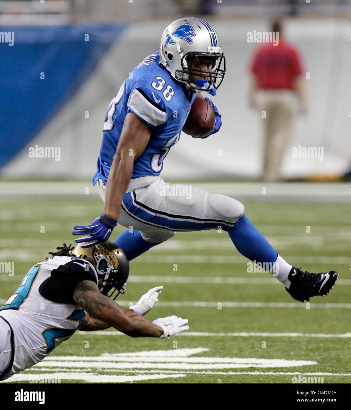 Detroit Lions running back George Winn (38) jumps over Jacksonville ...