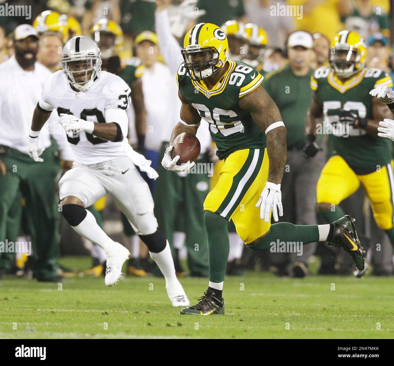 Green Bay Packers' Mike Neal runs with the ball after recovering a ...