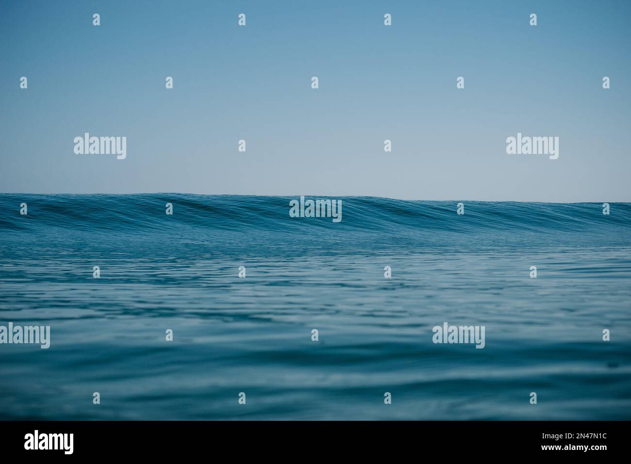 A landscape scene of blue sea waves with sunset sky, for wallpaper ...