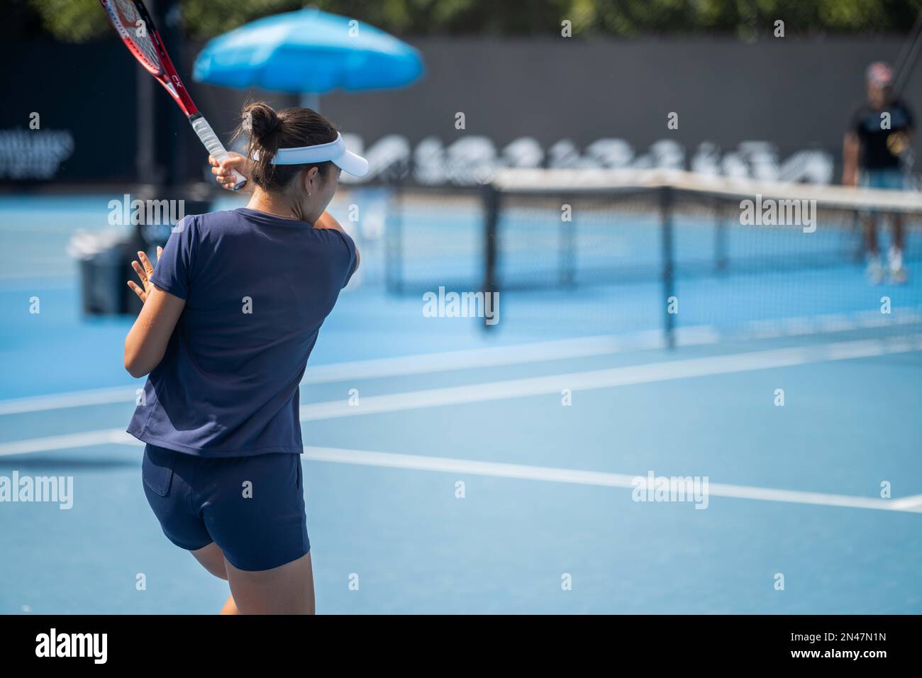 female Professional athlete Tennis player playing on a court in a ...