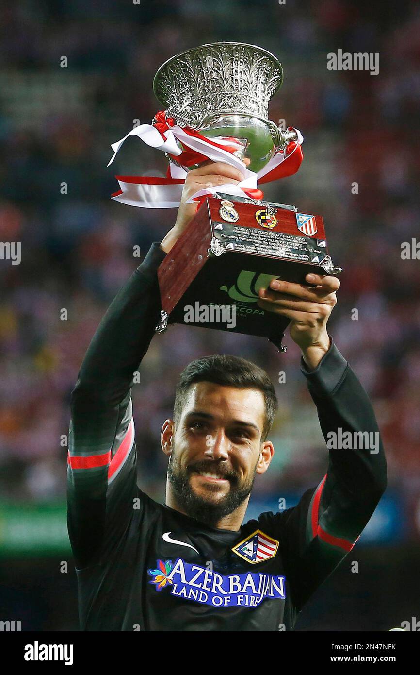 Atletico goalkeeper Moya celebrates the victory with the trophy during ...