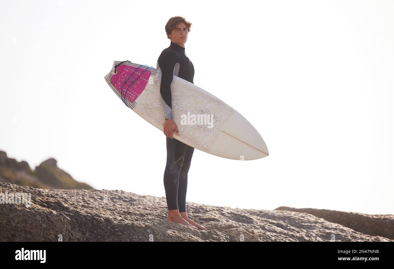 Surfing, man with surfboard for sports outdoor, beach rocks and travel ...