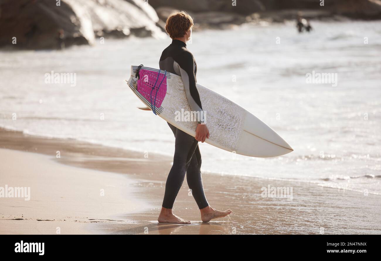 Surfing on beach, man with surfboard for sport outdoor, ocean and ...