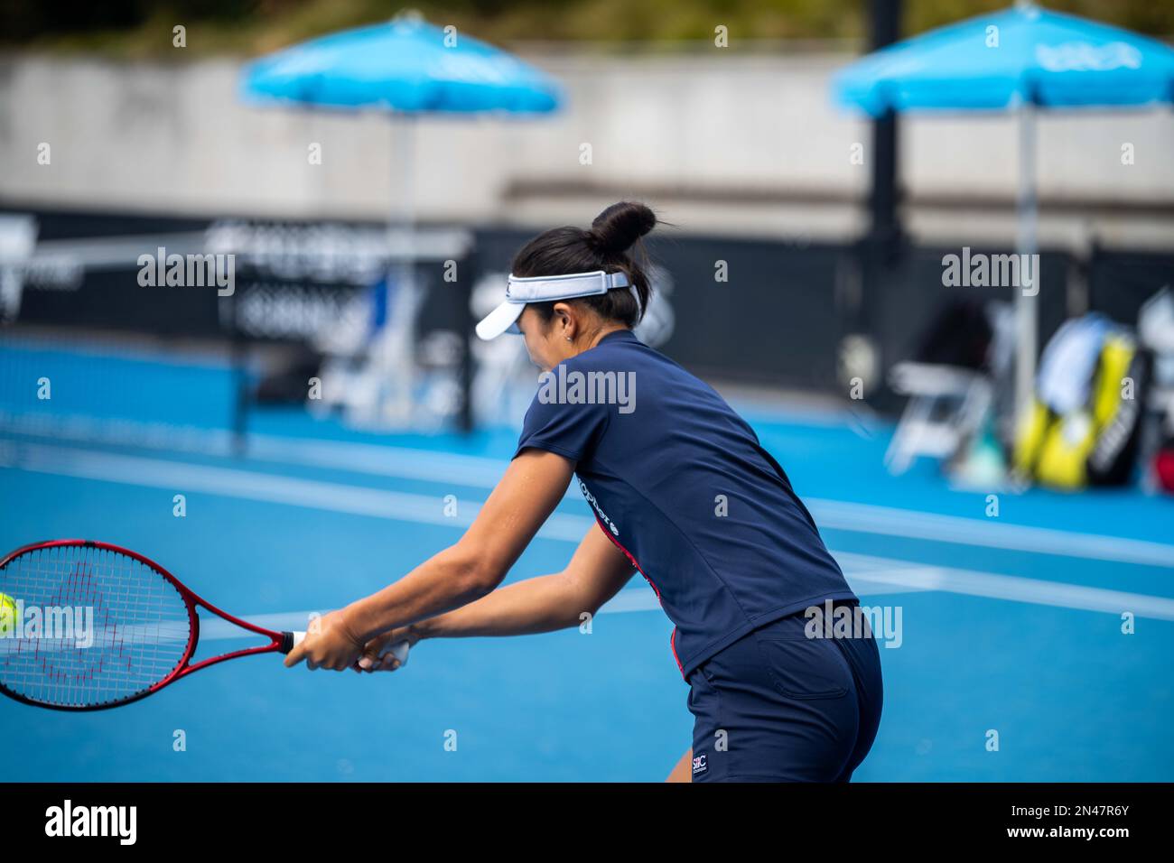 Tennis player serving in a tennis match, with leg drive in a game of ...