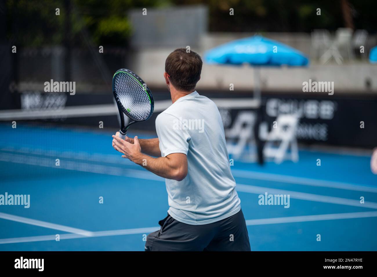 Tennis player serving in a tennis match, with leg drive in a game of ...