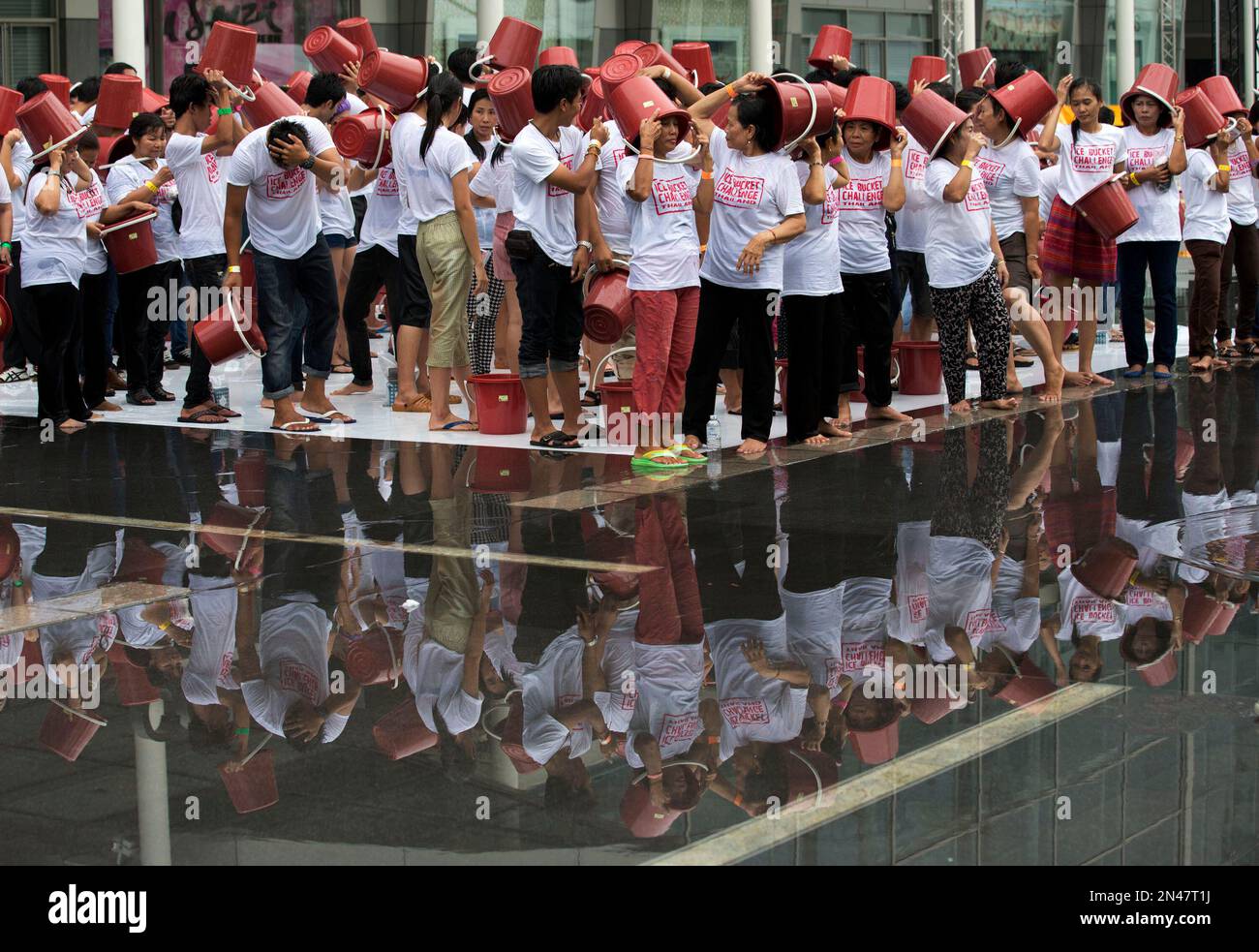Thais hold buckets over head after they splashed ice water to them ...
