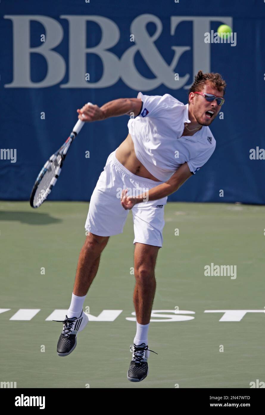 Jerzy Janowicz, of Poland, returns a shot against David Goffin, of ...