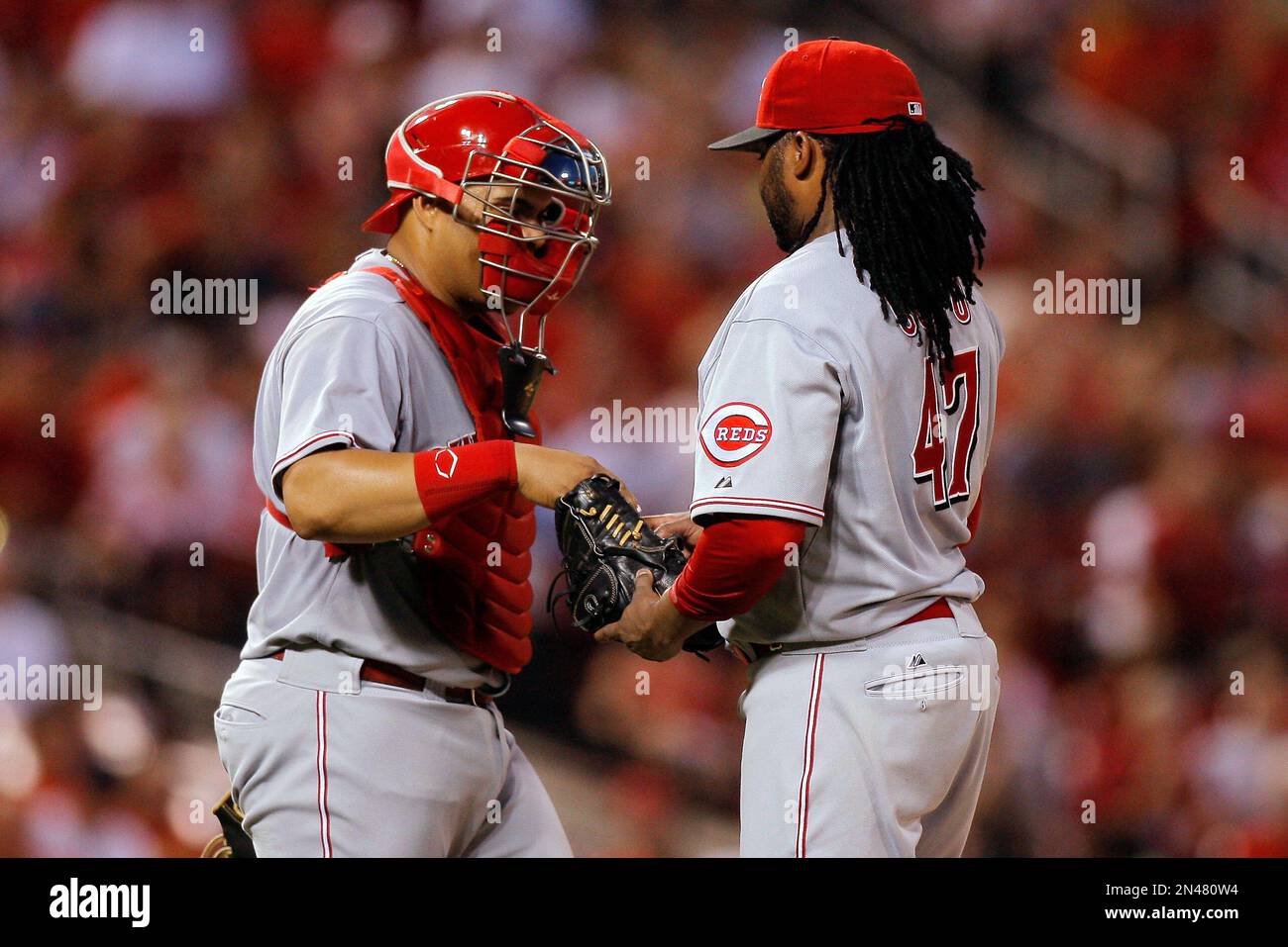 Cincinnati Reds catcher Brayan Pena, left, hands a new ball to starting ...