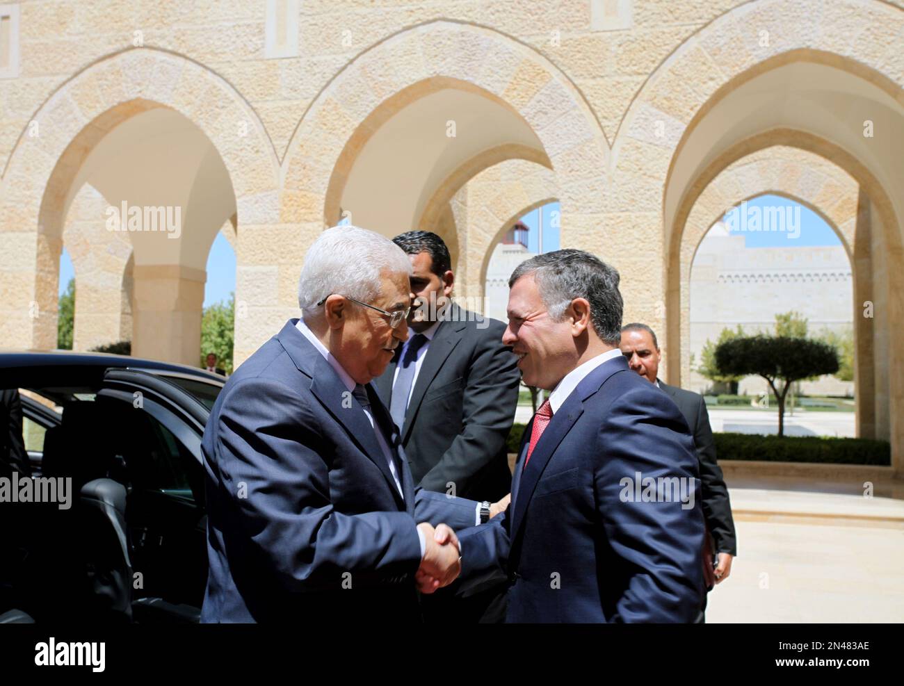 Palestinian President Mahmoud Abbas, left, is welcomed by King Abdullah ...