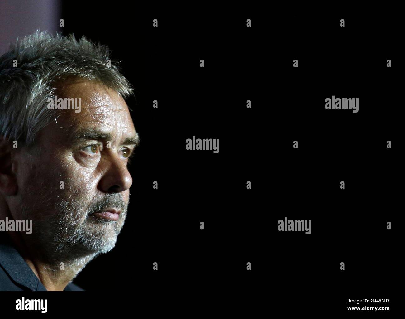 French director Luc Besson listens to reporters' question during a ...