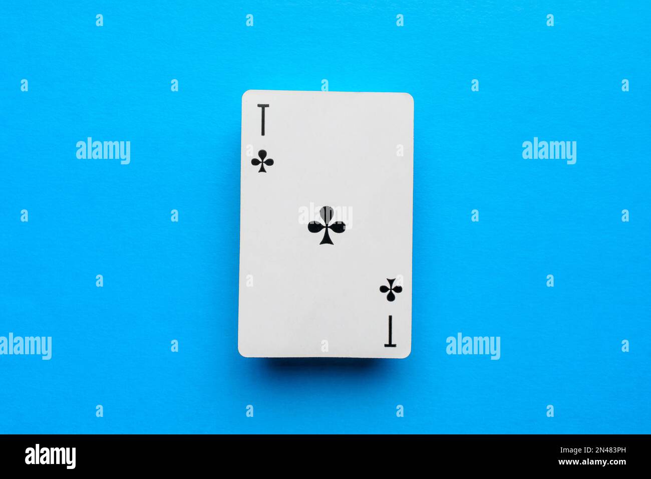Playing card ace of clubs on a blue background Stock Photo - Alamy