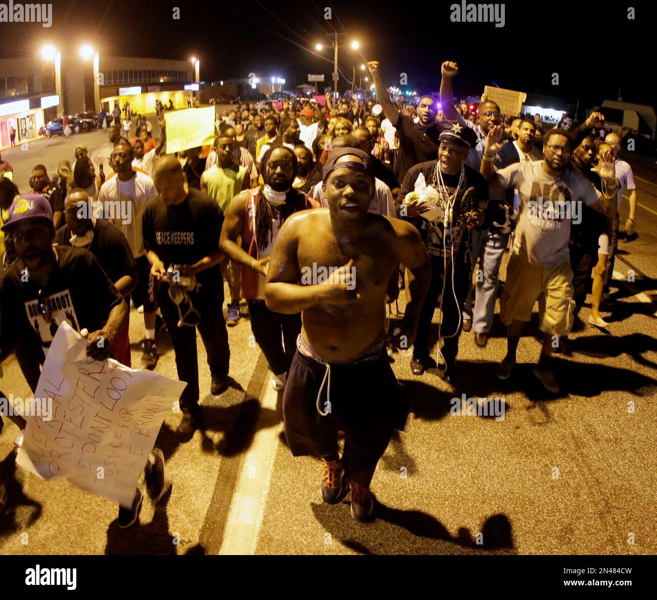 People march Tuesday, Aug. 19, 2014, during a rally for Michael Brown ...