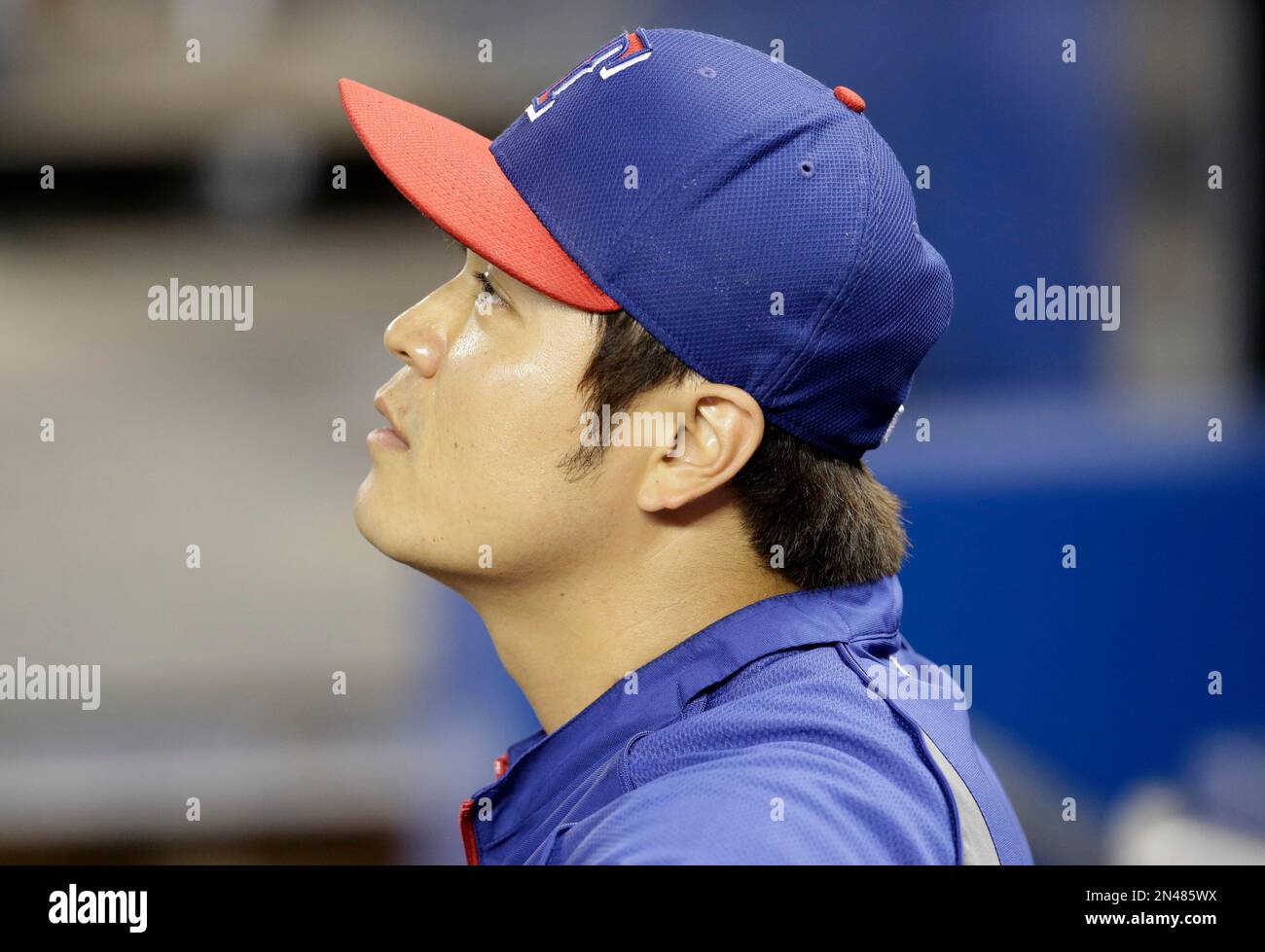 Texas Rangers left fielder Shin-Soo Choo looks out from the dugout ...