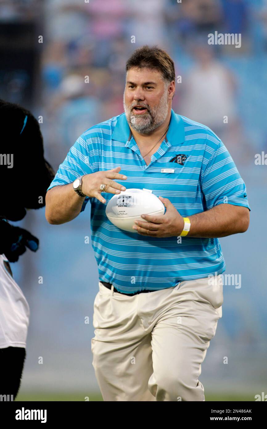 Former Carolina Panther Mike Fox runs onto the field as Panther former ...