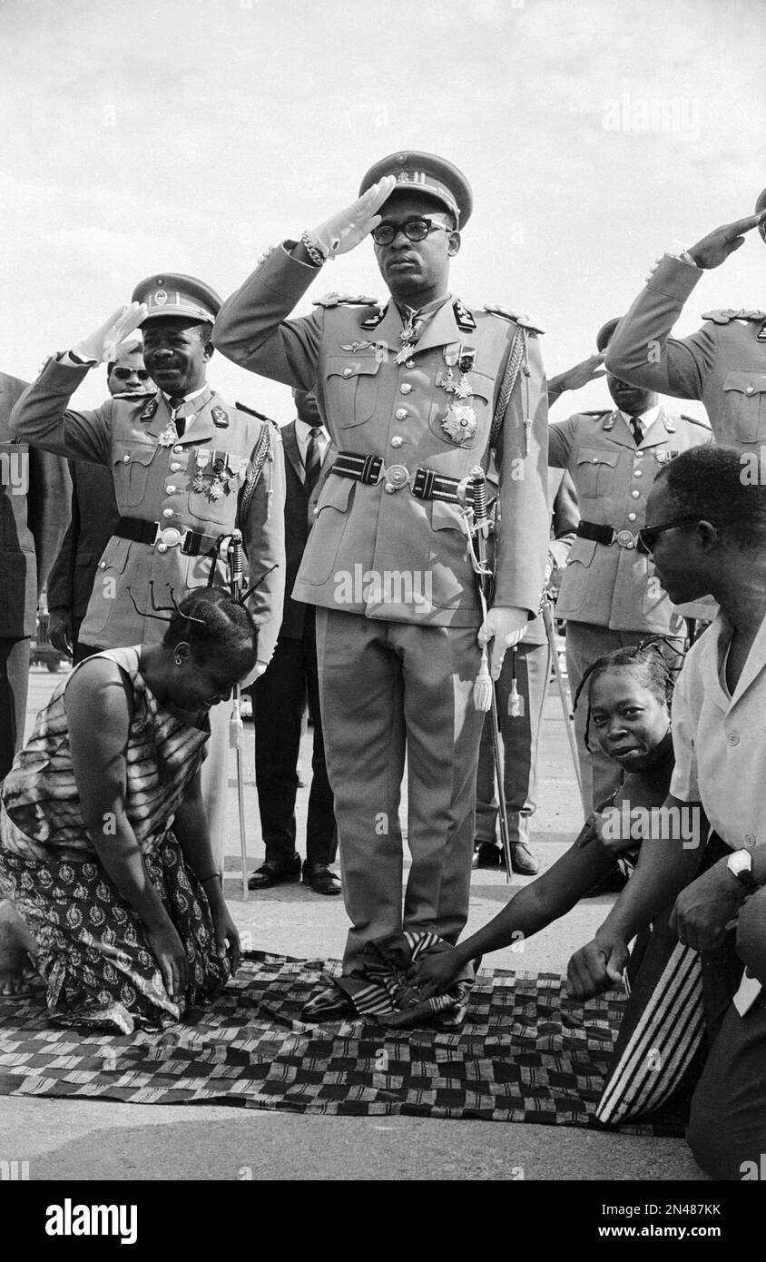 Lieutenant General Joseph Mobutu is seen having his shoes polished ...