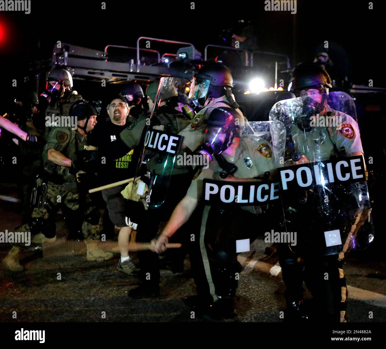 A man is detained after a standoff between protesters and police Monday ...
