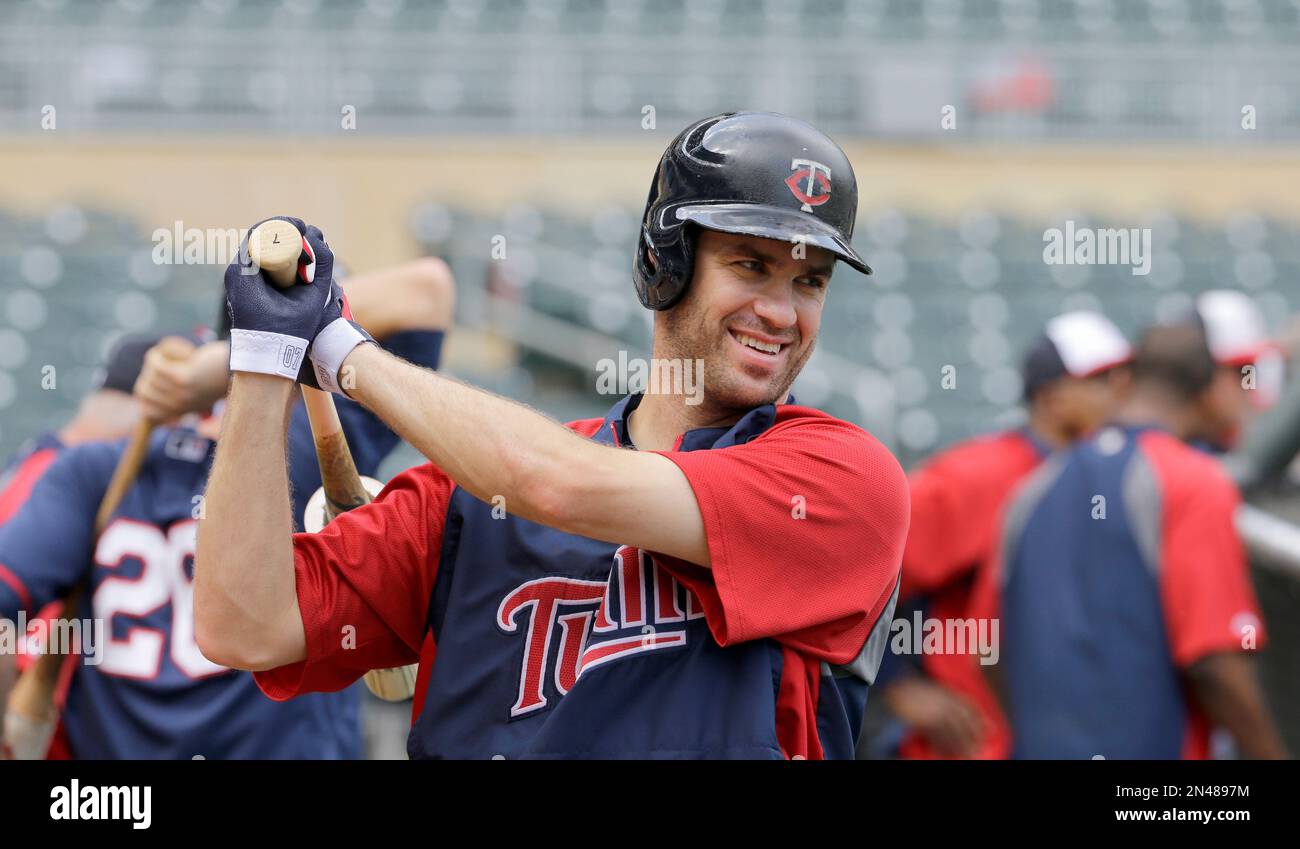 Minnesota Twins first baseman Joe Mauer smiles as he warms up before a ...