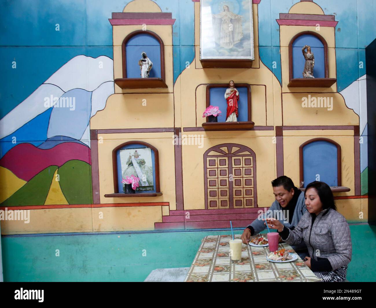 In this Aug. 16, 2014 photo, a couple has a taste of "Hornado" at La ...