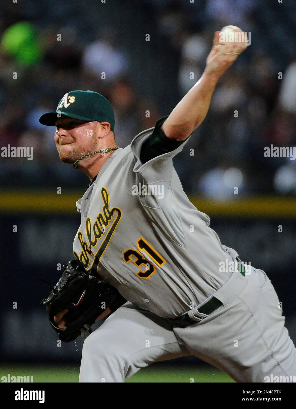 Oakland Athletics starting pitcher Jon Lester delivers to the Atlanta ...