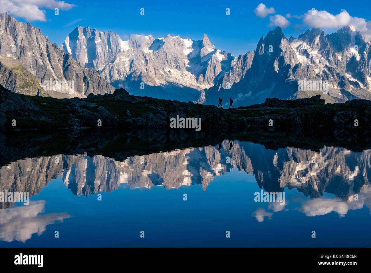 The peaks of the Mont Blanc massif are reflecting on the surface of Lacs des Chéserys, two ...